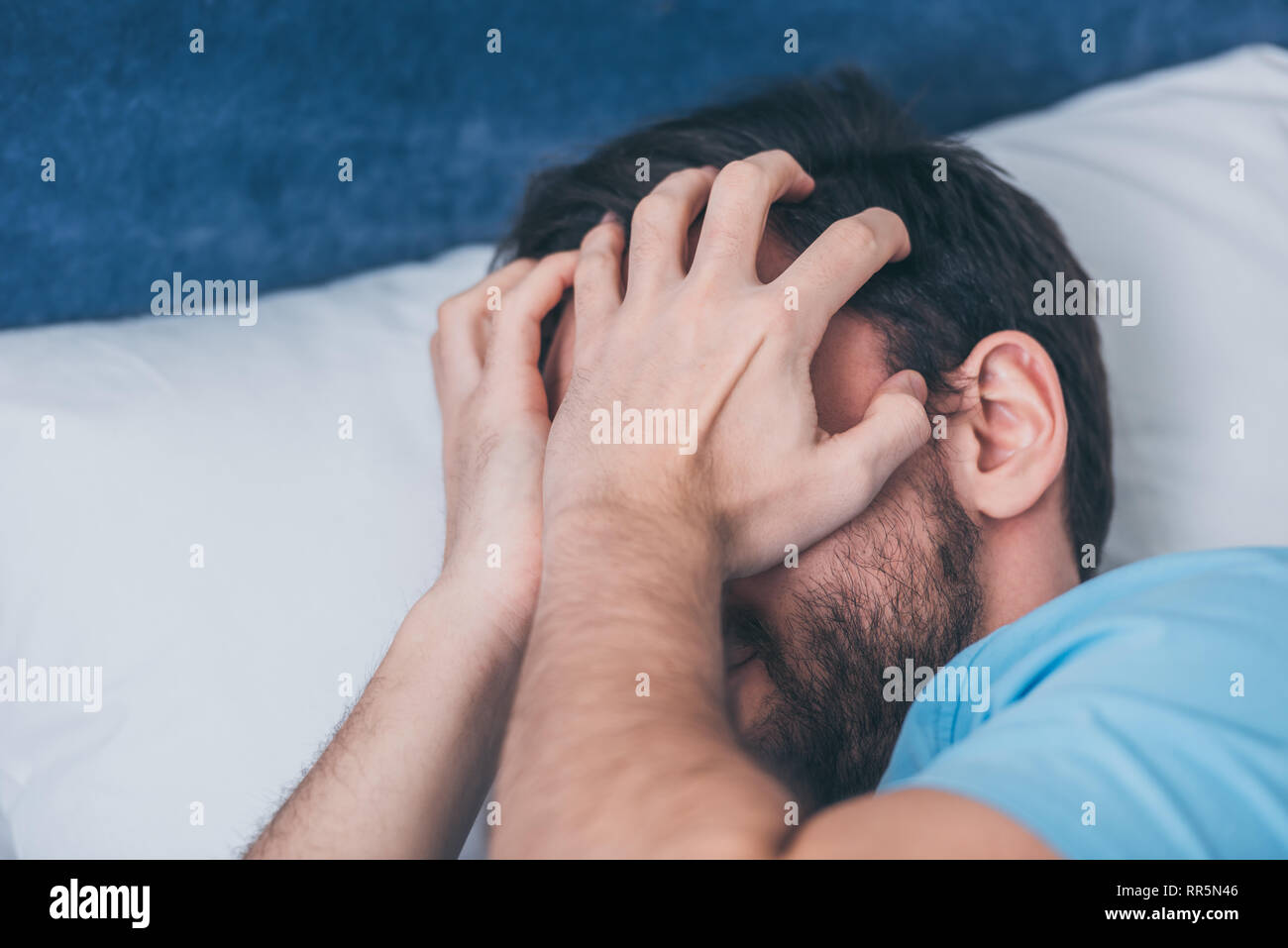 Man hands face bed hi-res stock photography and images - Alamy