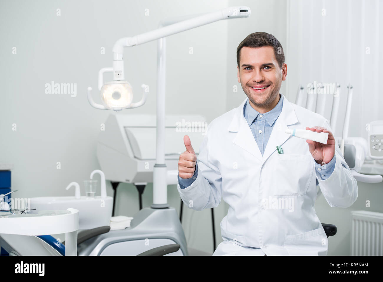 Dentist holding toothpaste showing hi-res stock photography and images ...