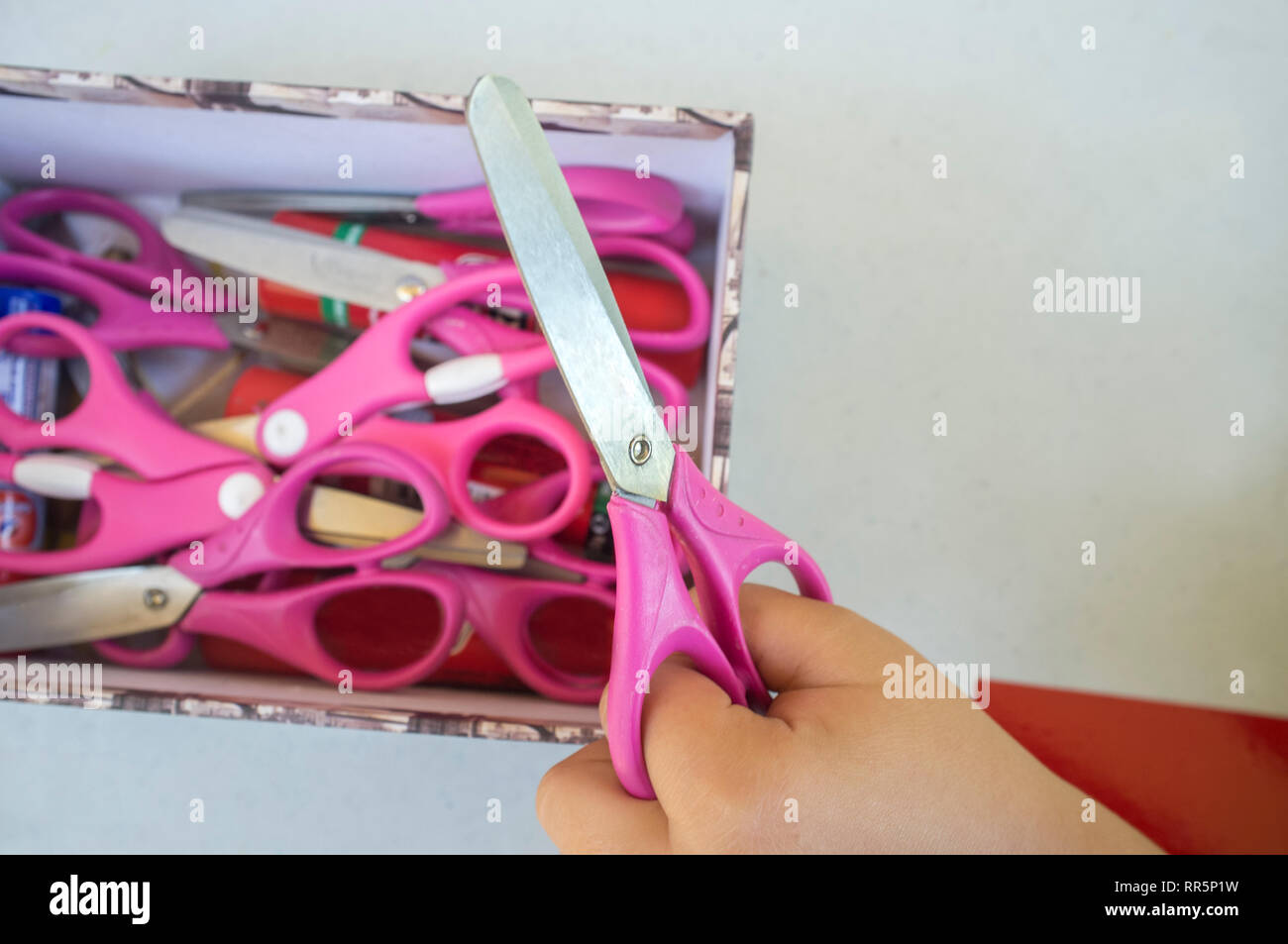 Hand with start children safety scissors and box. Overhead shot Stock ...
