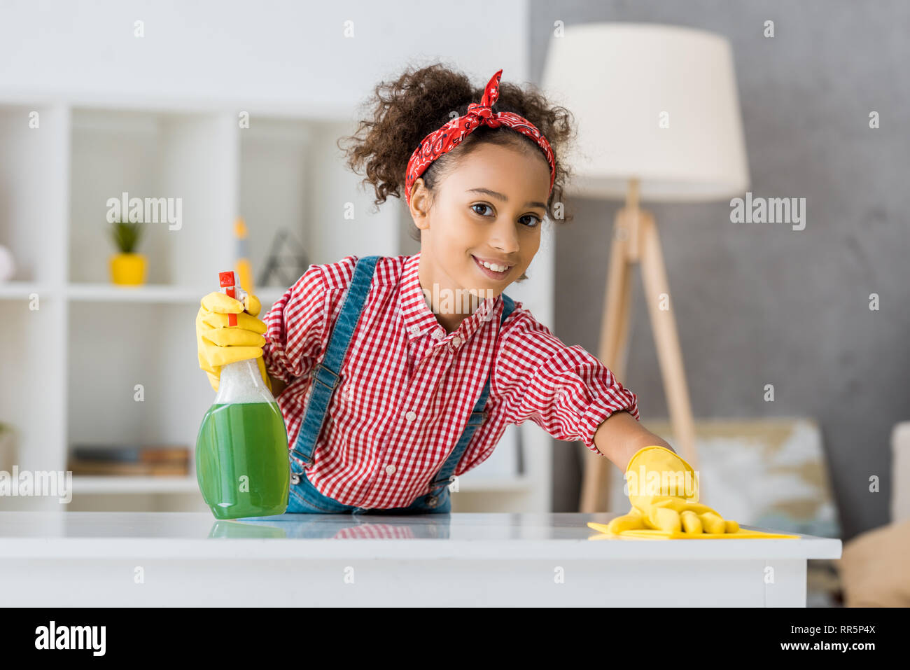cute african american child cleaning table with yellow rag Stock Photo ...