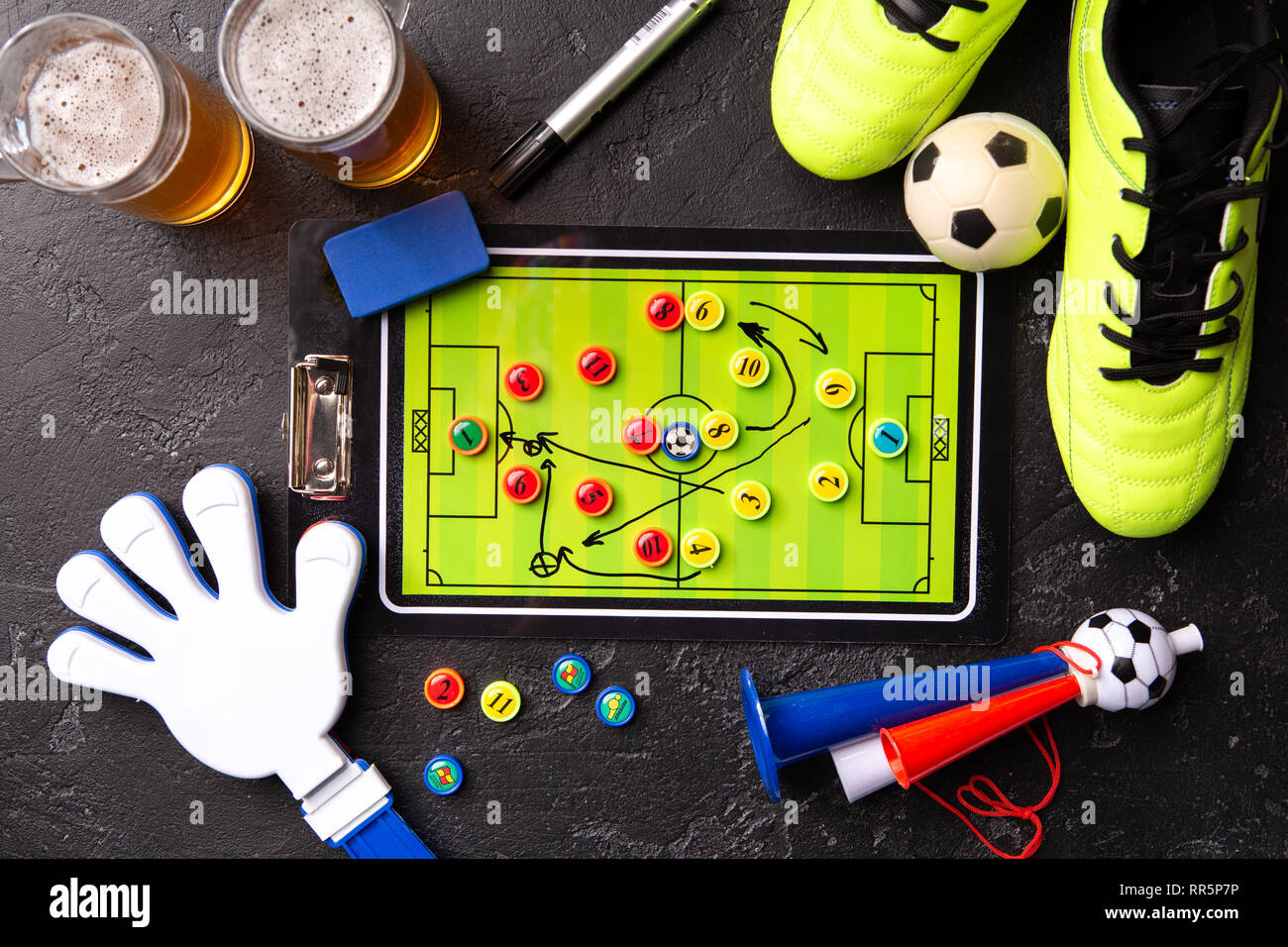 Photo on top of two mugs of foam beer, table football, ball, football ...