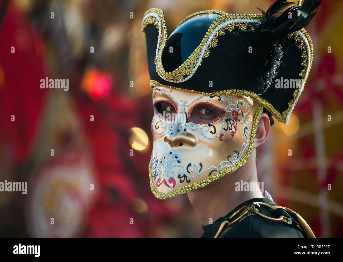 A man dressed with a carnival costume is seen looking on during the ...