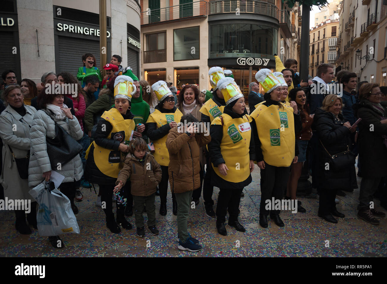 People dressed as bottles of beer are seen on the street as they watch ...