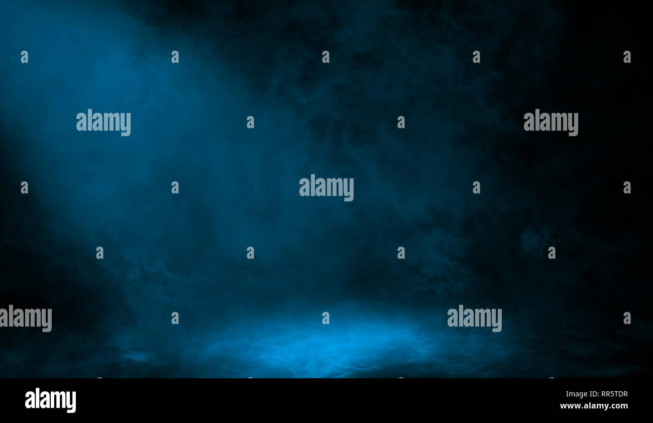 Abstract blue spotlight with smoke mist fog on a black background ...