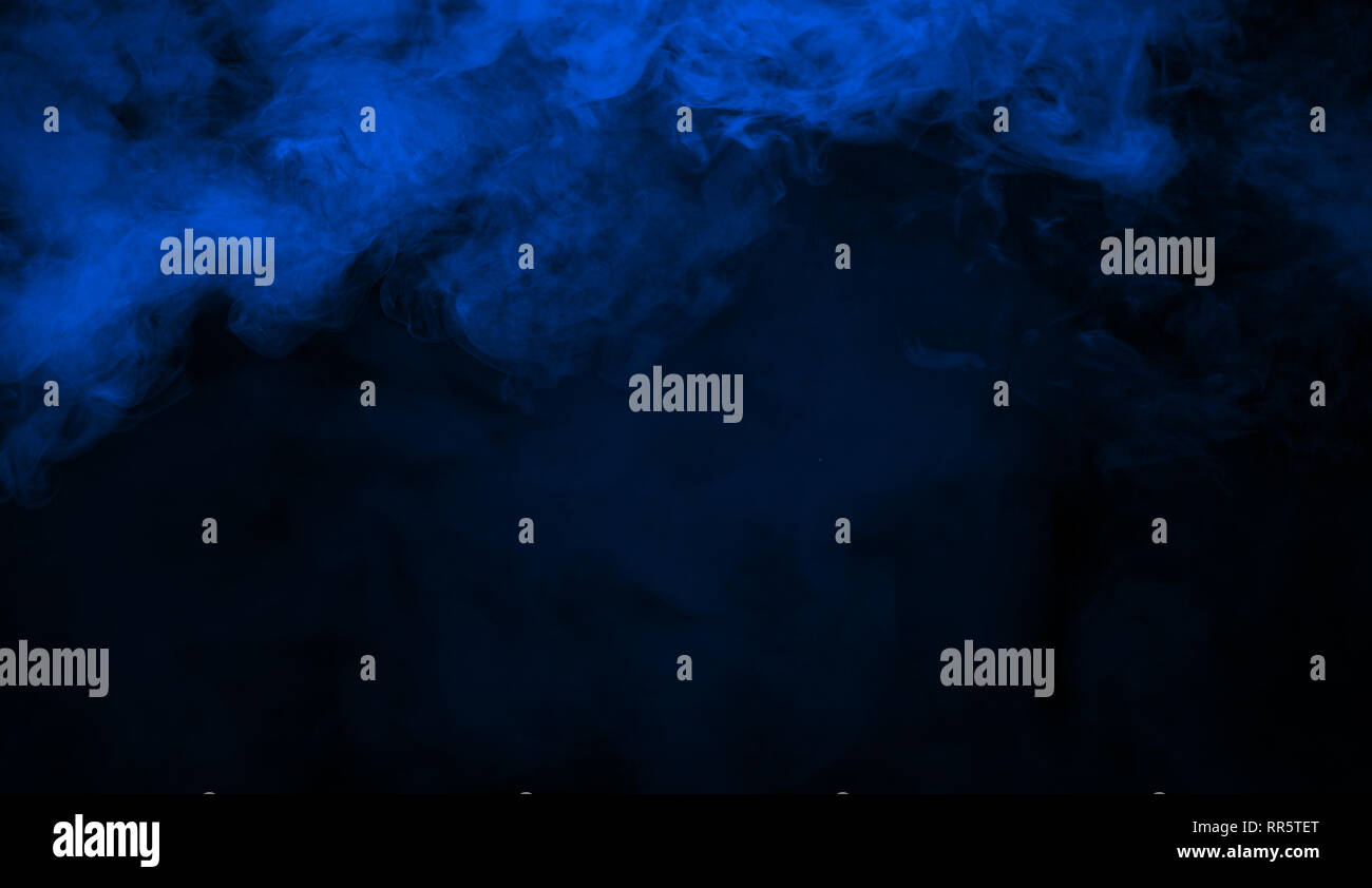 Abstract blue smoke mist fog on a black background. Texture background ...