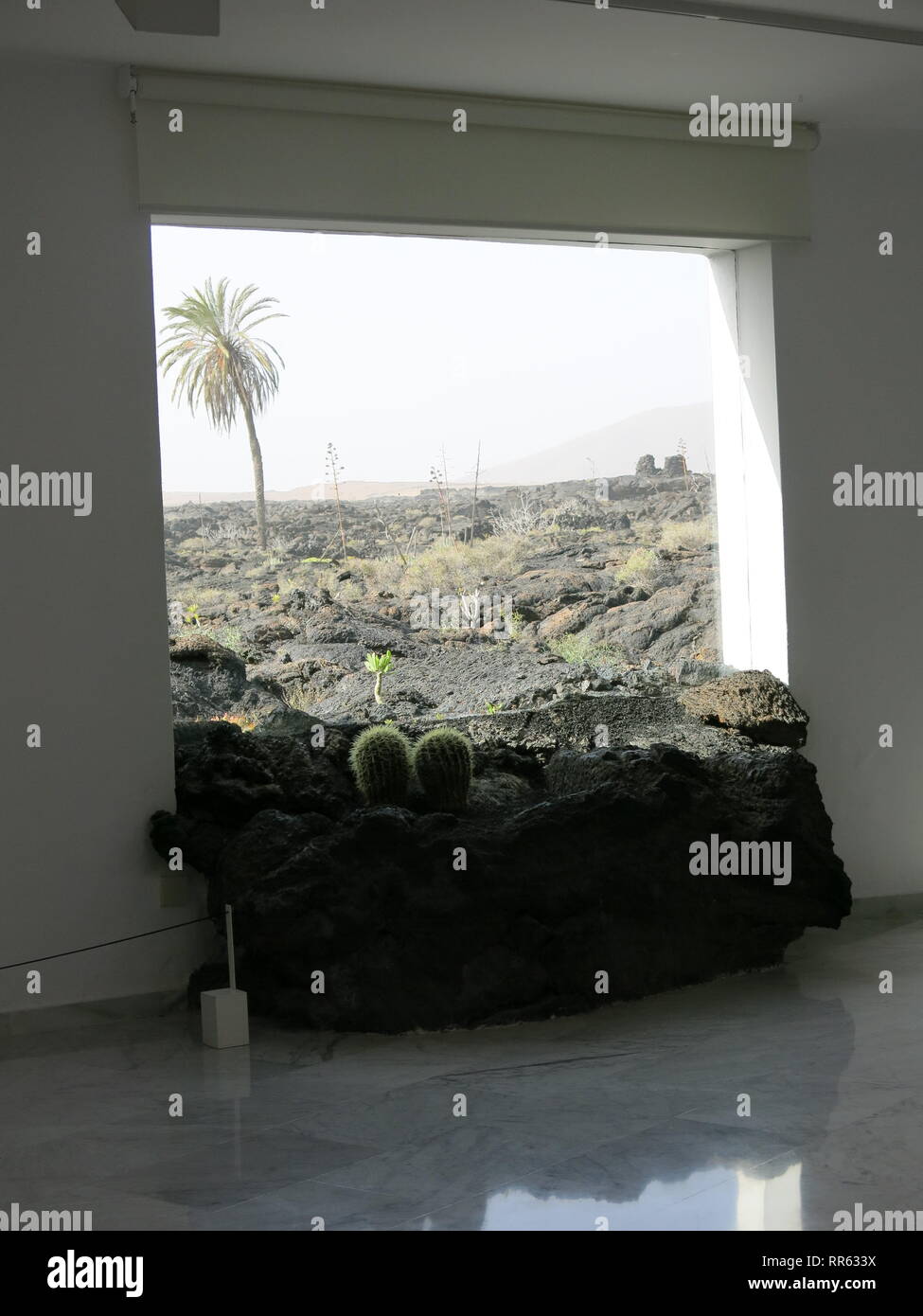 A large picture window in the whitewashed parlour frames the view of ...