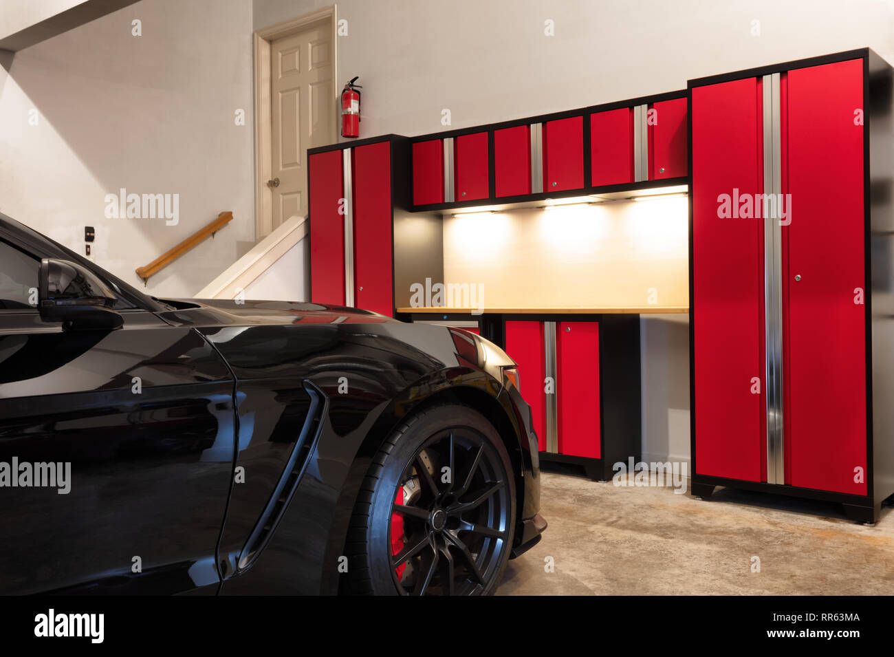 Residential home garage interior highly organized and clean with car ...