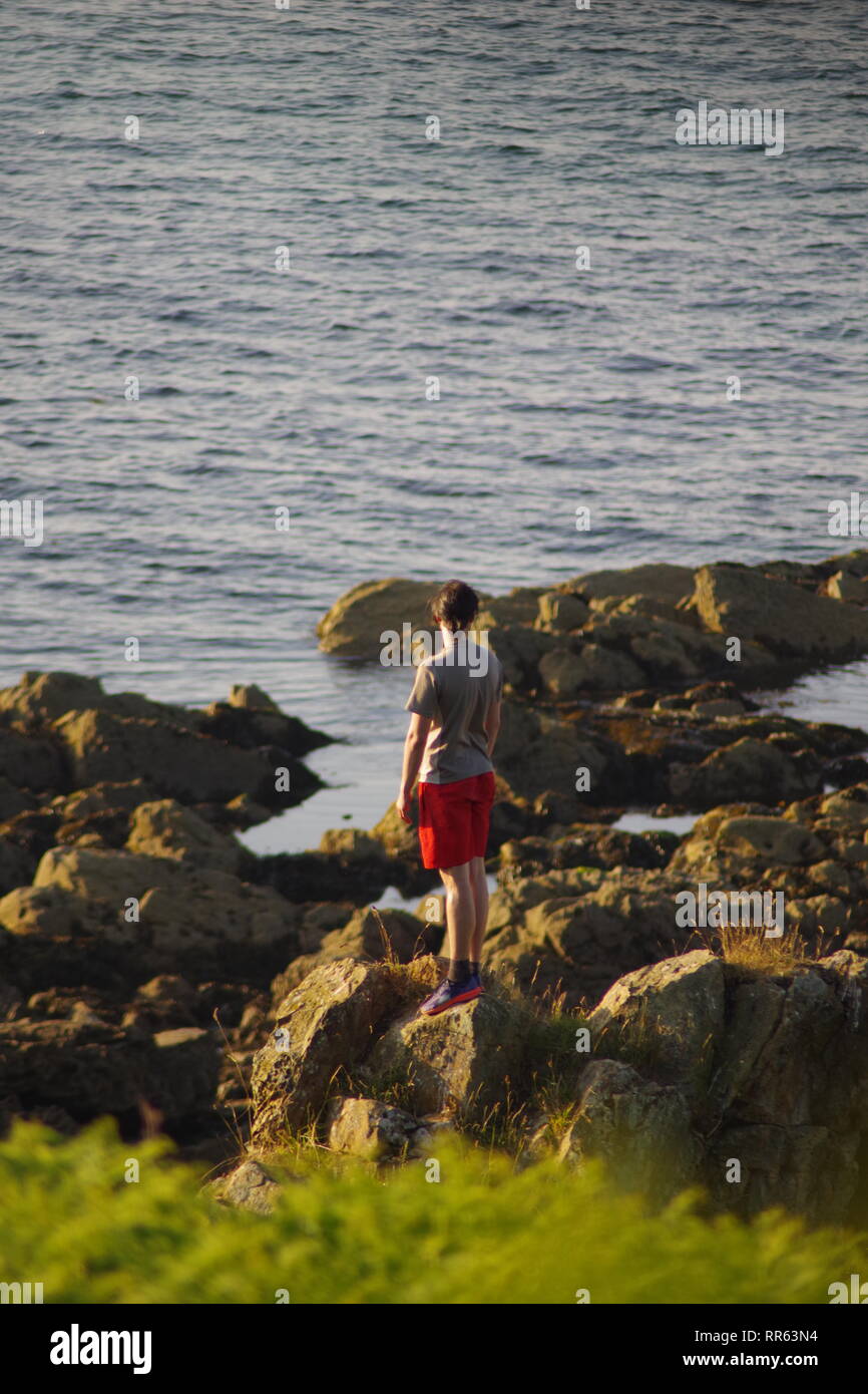 Rock Climber Free Climbing Maidens Rock, Sandstone Sea Stack near St ...