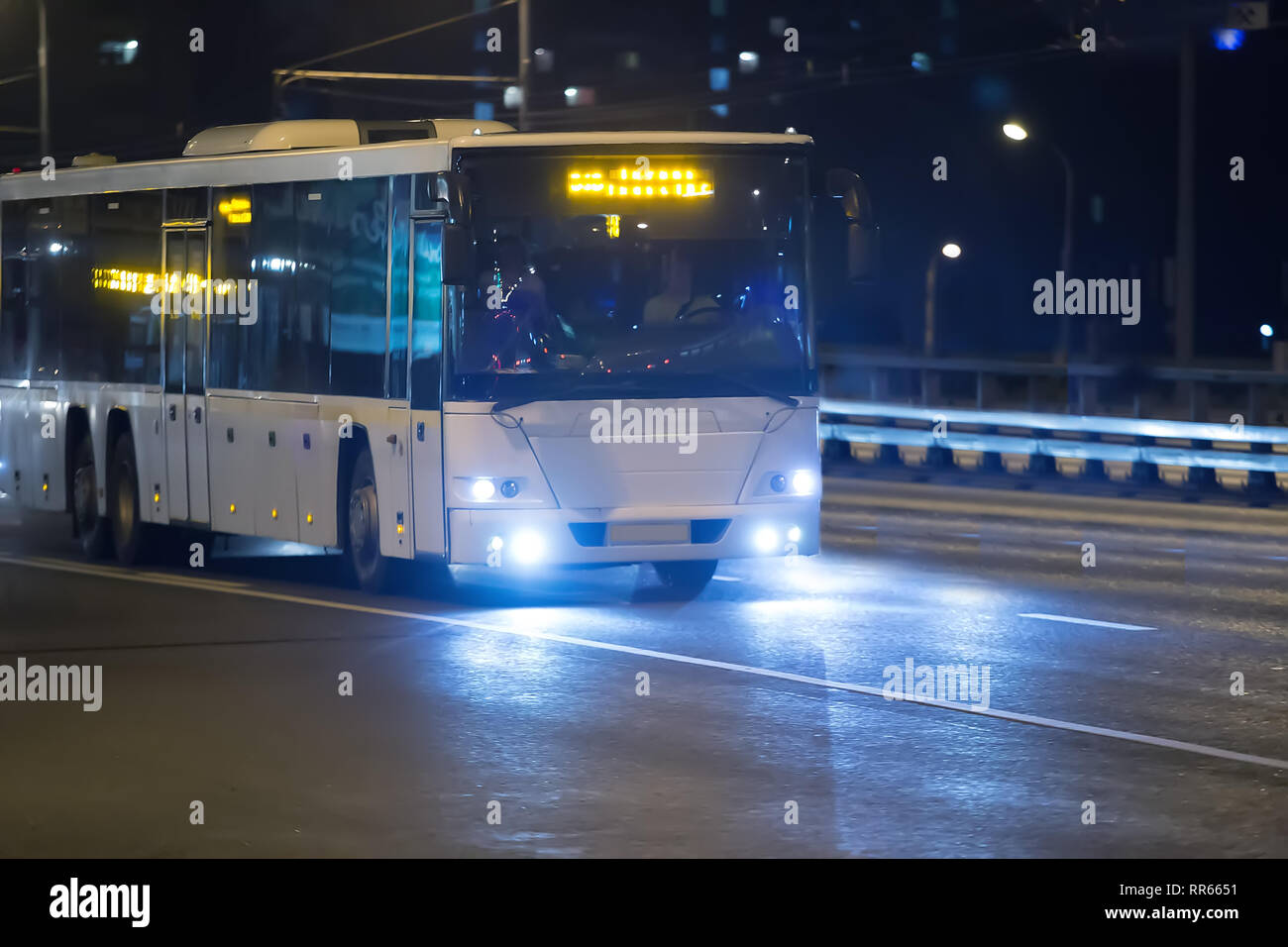 bus moves on city street at night Stock Photo - Alamy