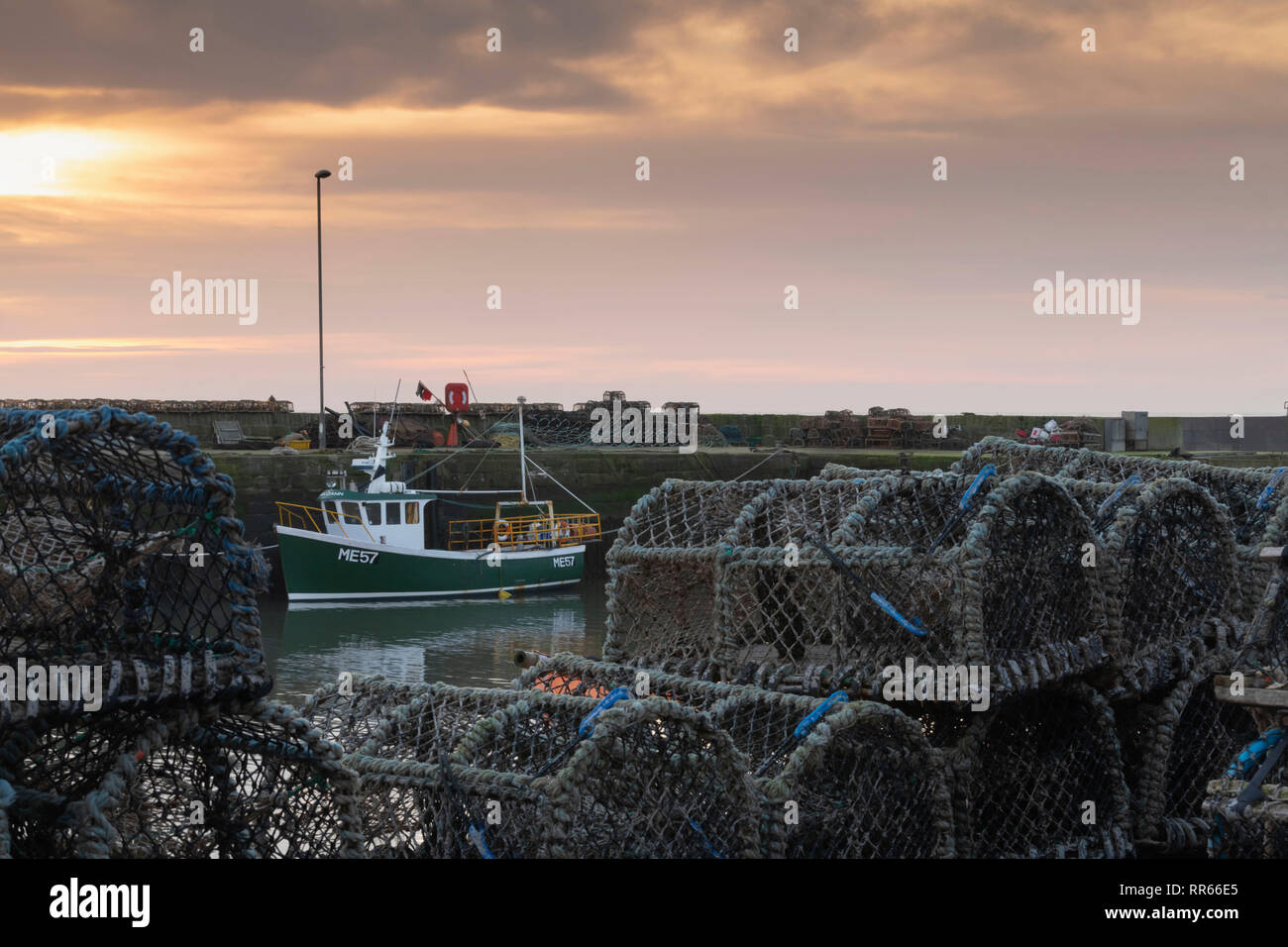 Lobster Traps Line the Quayside & Harbour Wall and a Fishing Boat is on ...