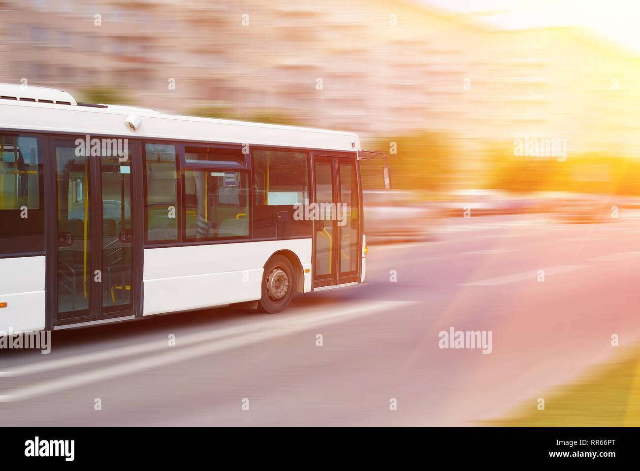 white city bus goes along street Stock Photo - Alamy