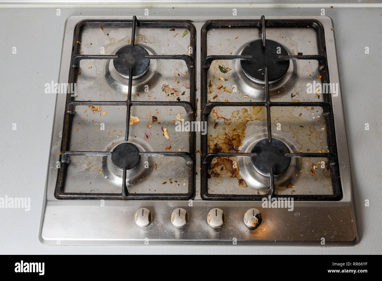 Dirty gas stove in the kitchen, top view. Gas stove with food remnants ...