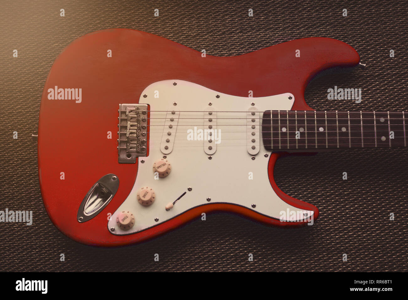 Red garnet electric guitar in a pattern texture background. Age worn ...