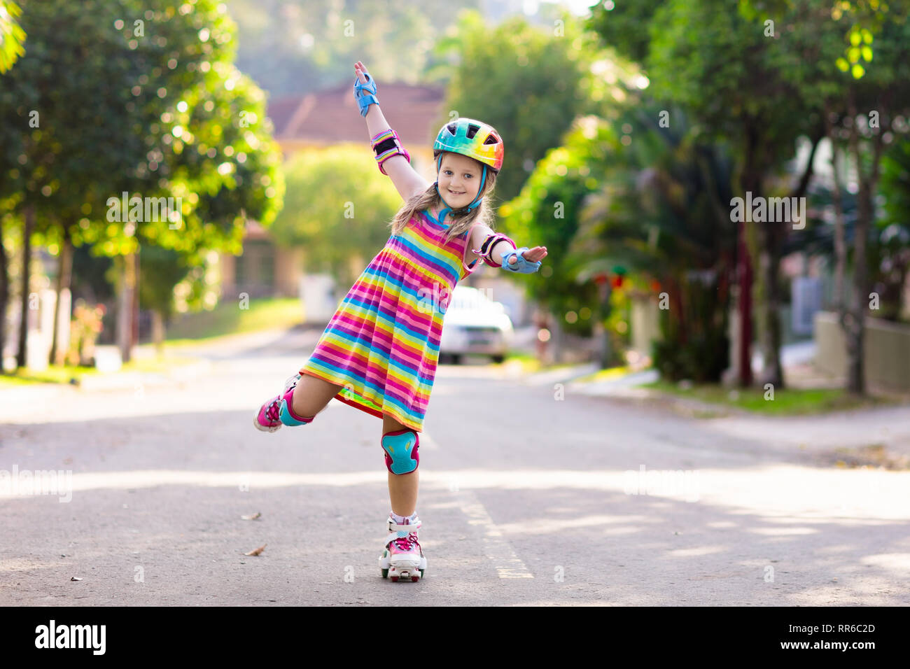 Child on inline skates in park. Kids learn to skate roller blades ...