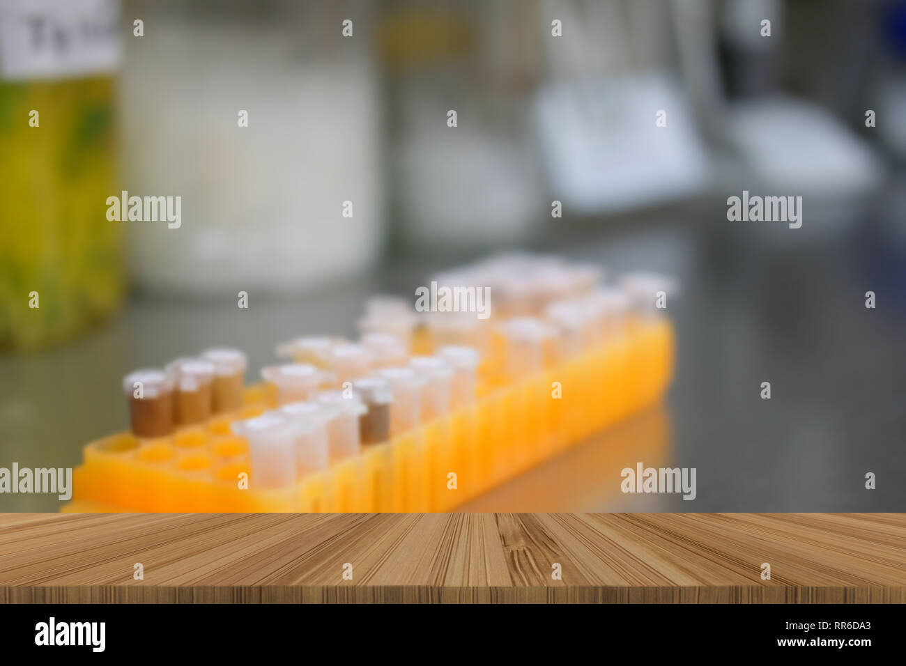 DNA sample in PCR tube microplate in lab with wood table for display ...