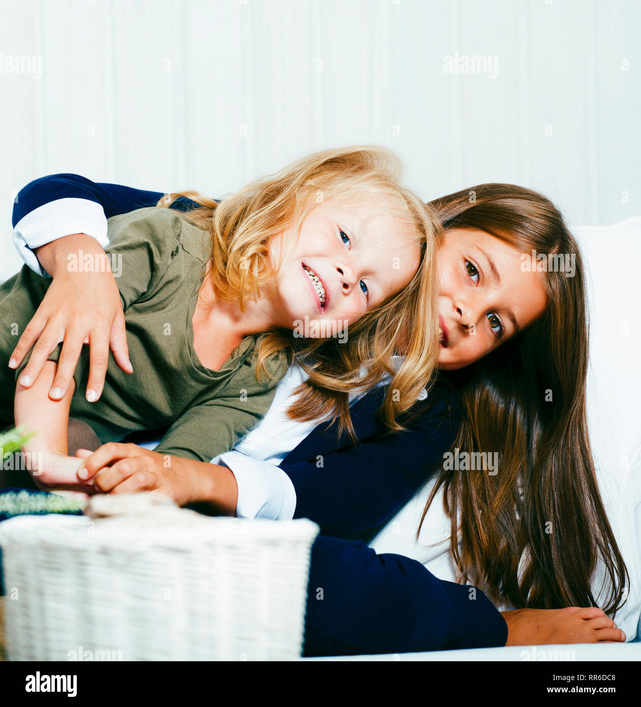 two cute sisters at home interior playing, little happy smiling girl in ...