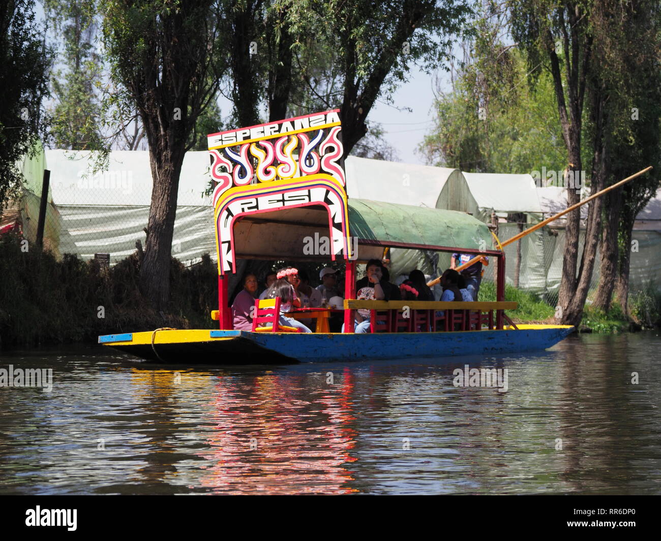 Colorful boat with tourists and gondolier at Floating Gardens in ...