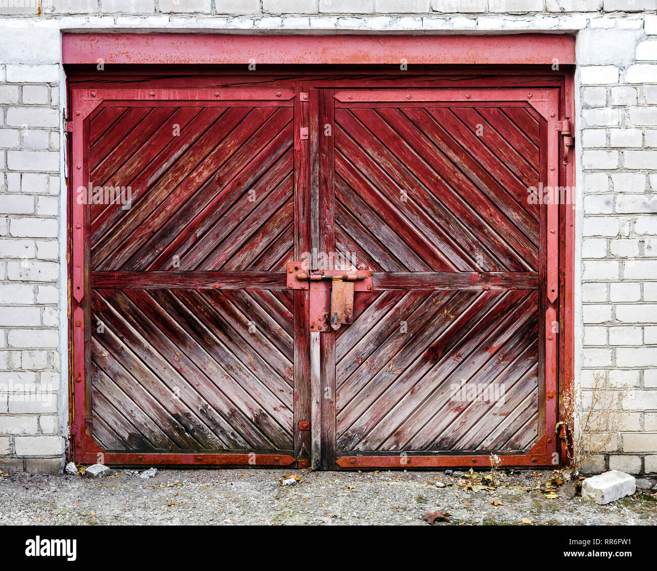 Old wooden gate in white brick wall. Architecture detail background ...