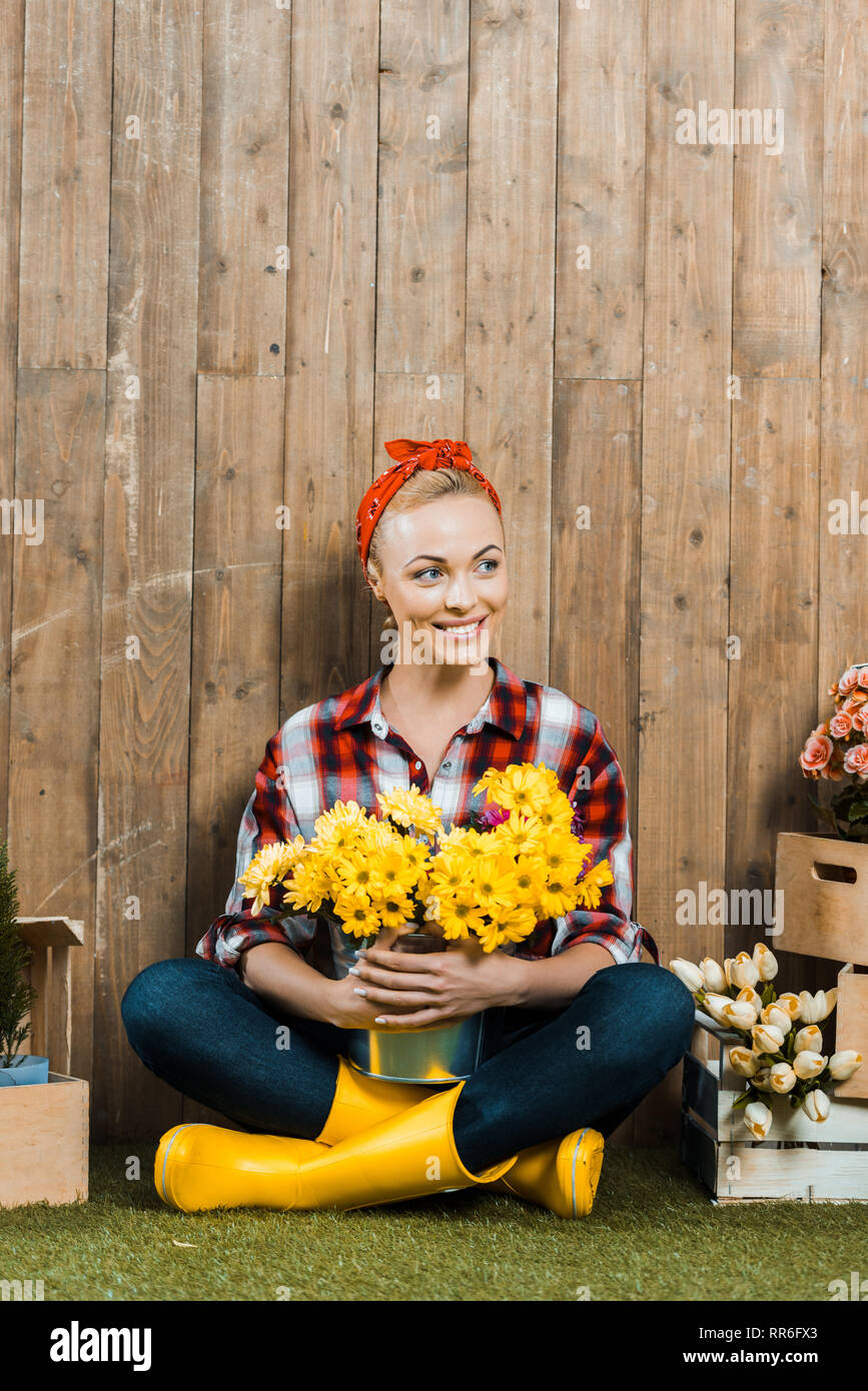 Woman holding bucket flowers hi-res stock photography and images - Alamy