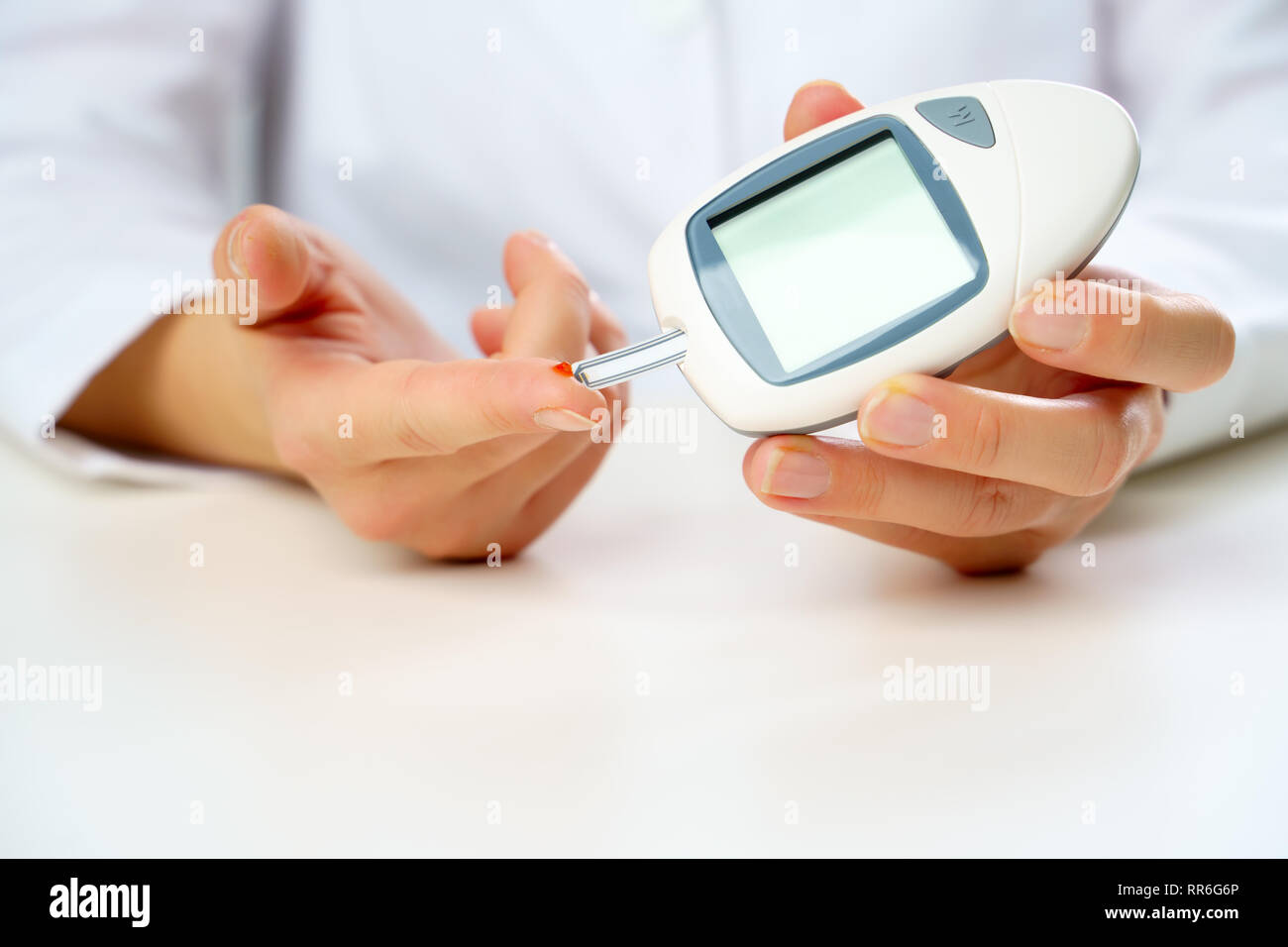 Picture of woman's hand with glucometer Stock Photo - Alamy
