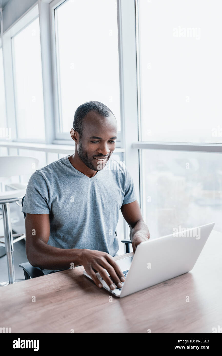 Professional male economist searches needed information on portable ...