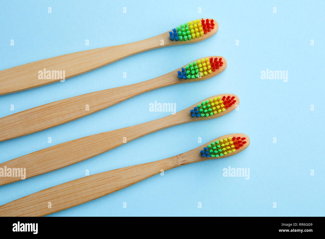 Picture of four toothbrushes with rainbow-colored bristles Stock Photo ...