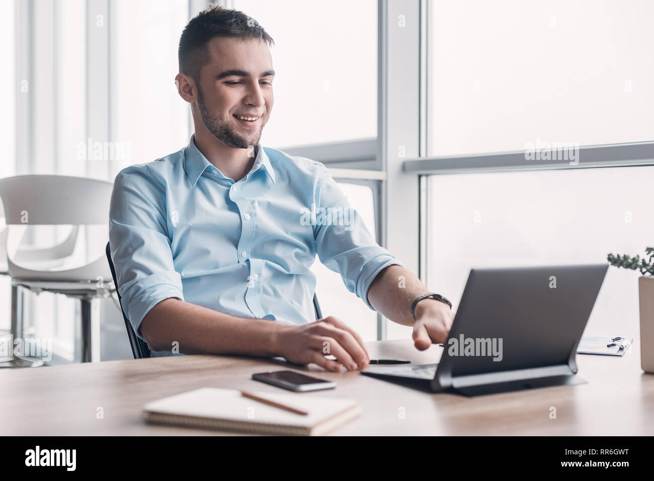 Professional male economist searches needed information on portable ...