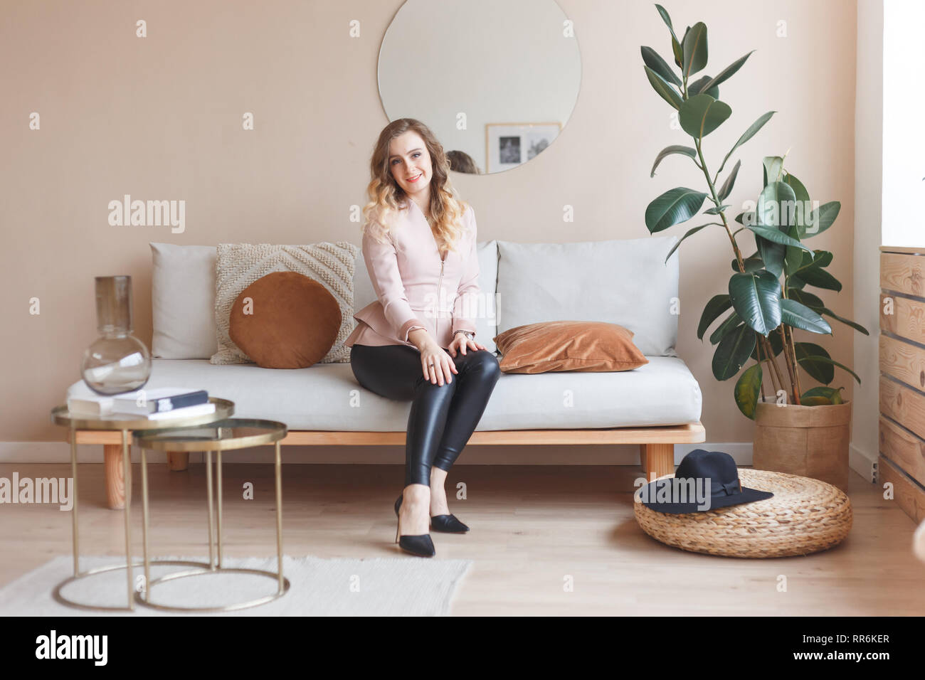Girl in leather pants and high heels in room interior Stock Photo - Alamy