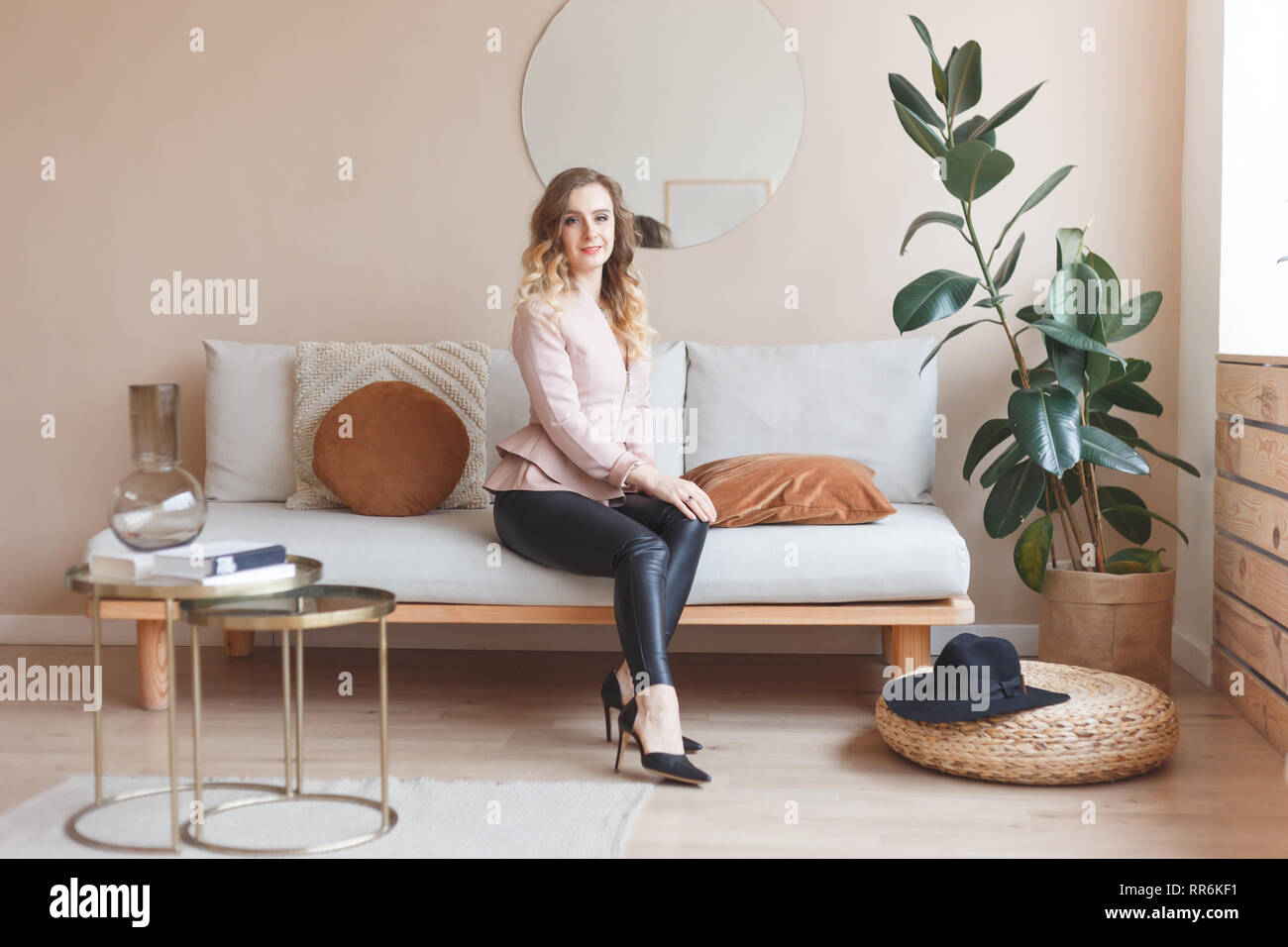 Girl in leather pants and high heels in room interior Stock Photo - Alamy