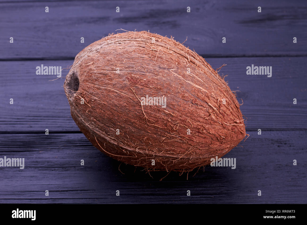 Tropical coconut on dark background Stock Photo - Alamy
