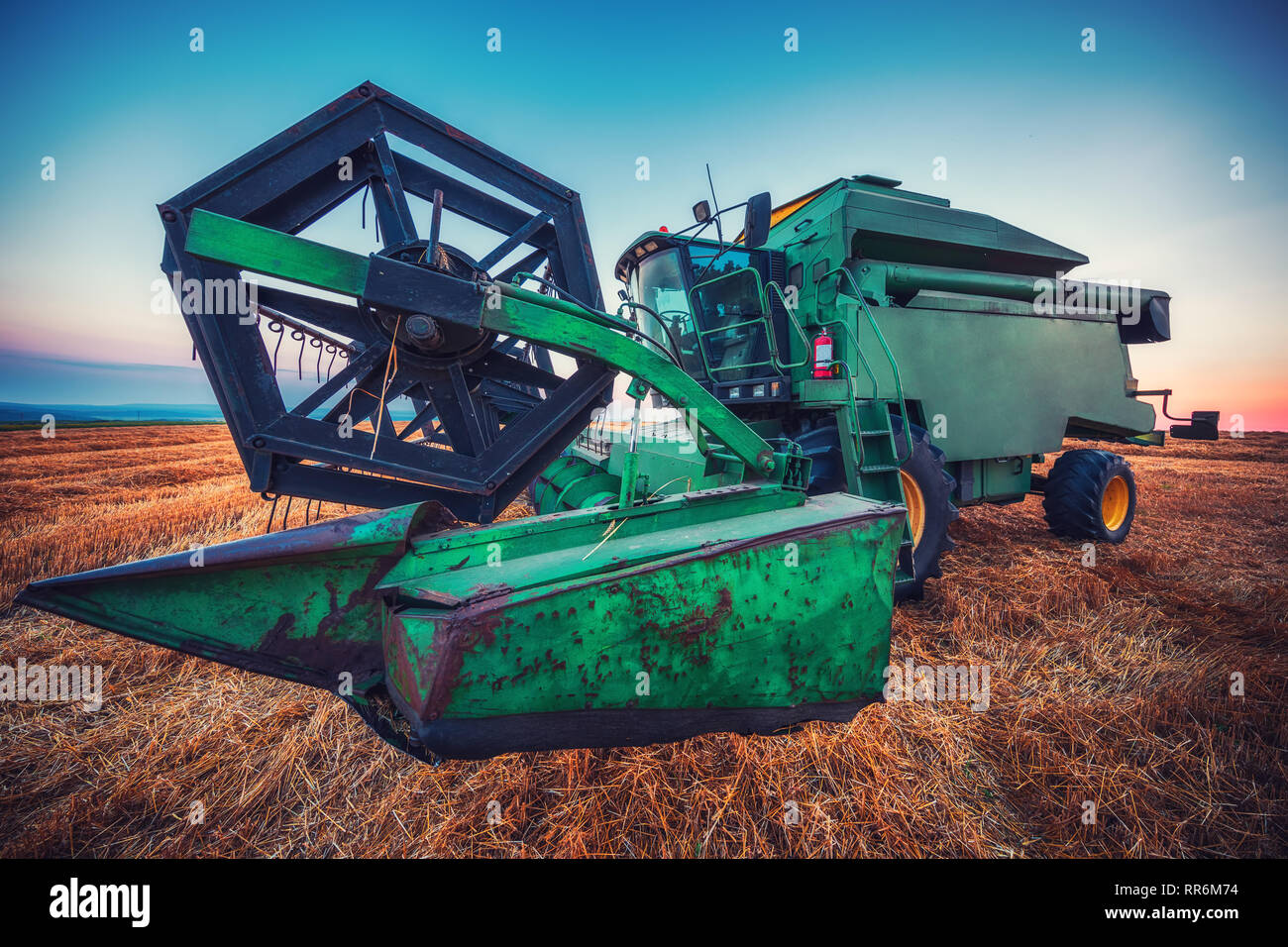 Combine harvester machine working in a wheat field at sunset Stock ...