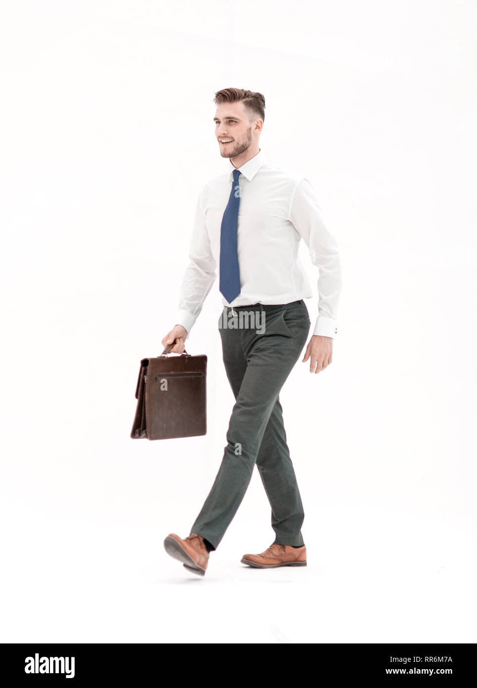 side view.smiling businessman confidently steps forward Stock Photo - Alamy
