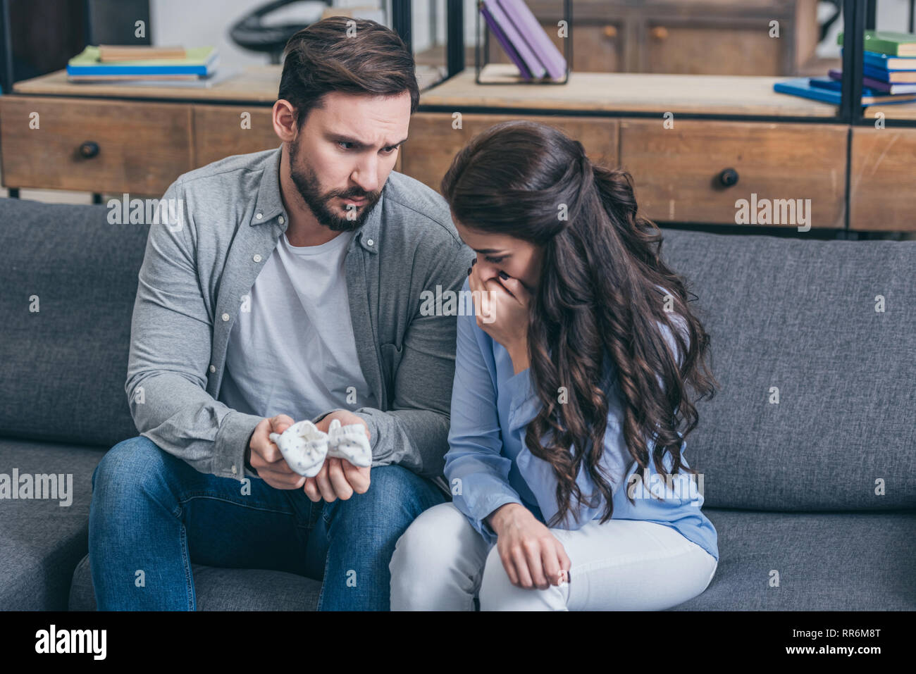 Couple woman crying on couch hi-res stock photography and images - Alamy
