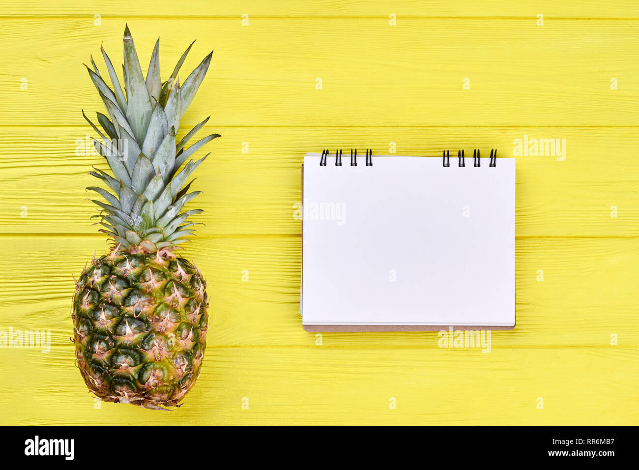 Pineapple and blank paper notepad Stock Photo - Alamy