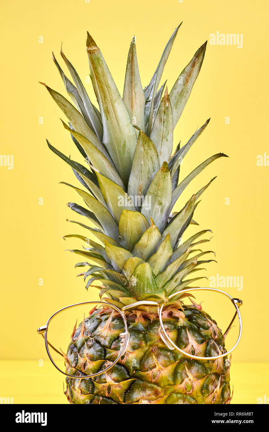 Green exotic pineapple on yellow background Stock Photo - Alamy