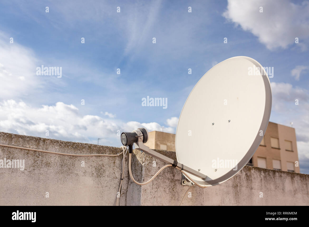 Old satellite dish on apartament building in Spain. Sunny nice day ...