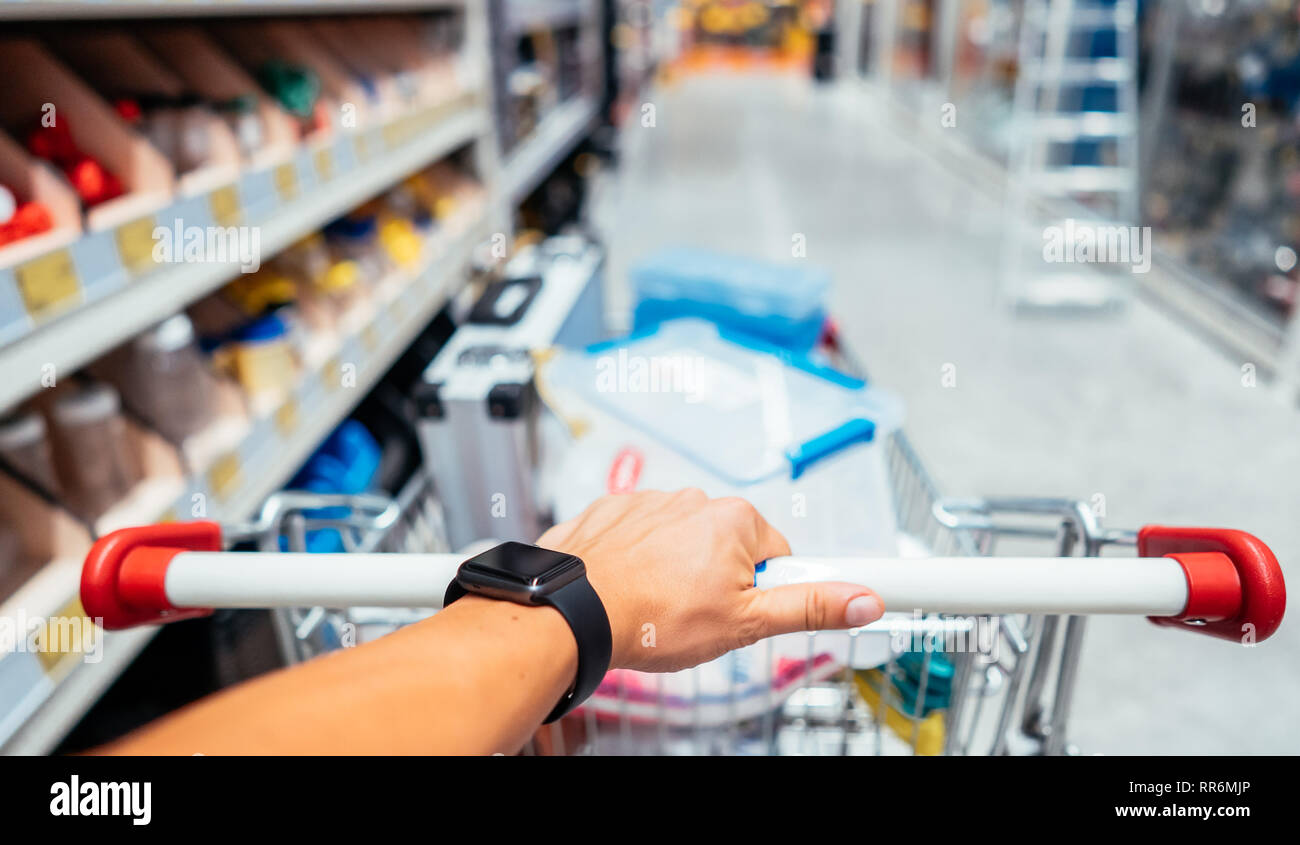 Human Hand Close Up With Shopping Cart in a Supermarket Walking Trough ...
