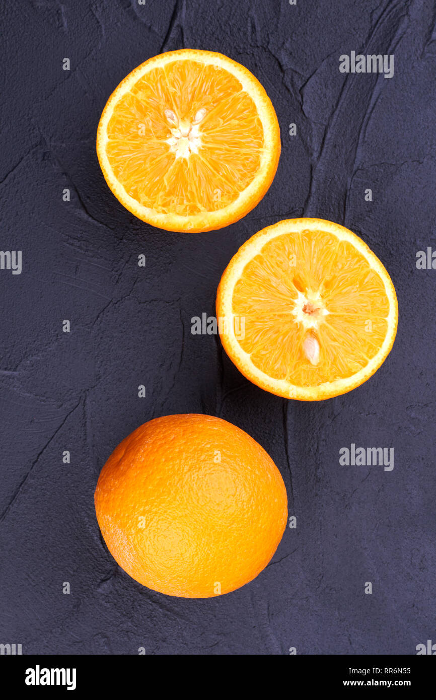 One whole and two halves of orange Stock Photo - Alamy
