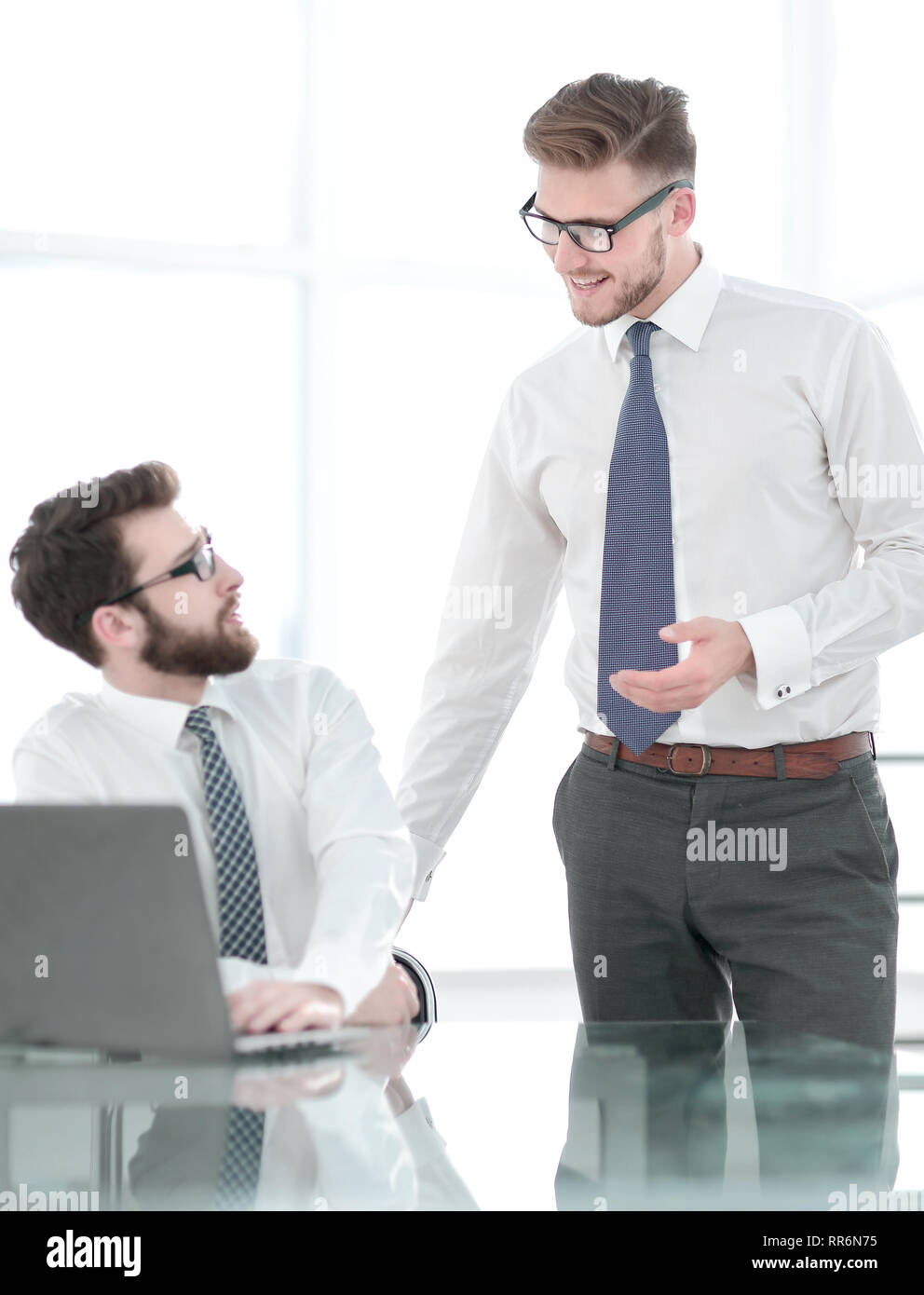 two employees discuss business issues near the office Desk Stock Photo ...