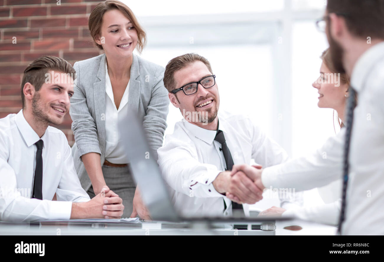 Manager shaking the hand of the customer Stock Photo - Alamy