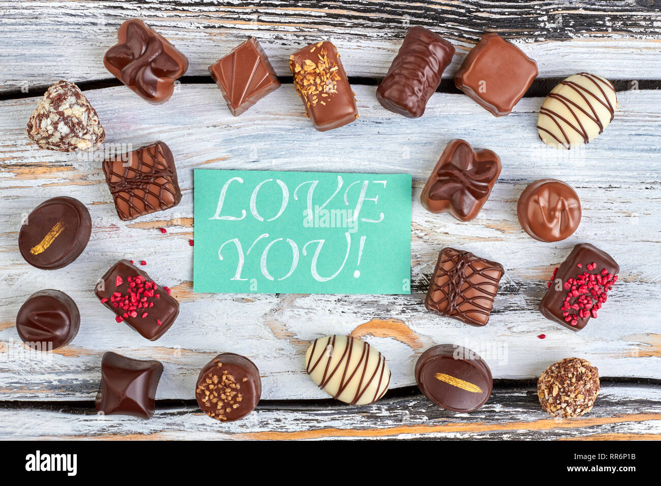Delicious chocolate candies and love message Stock Photo - Alamy
