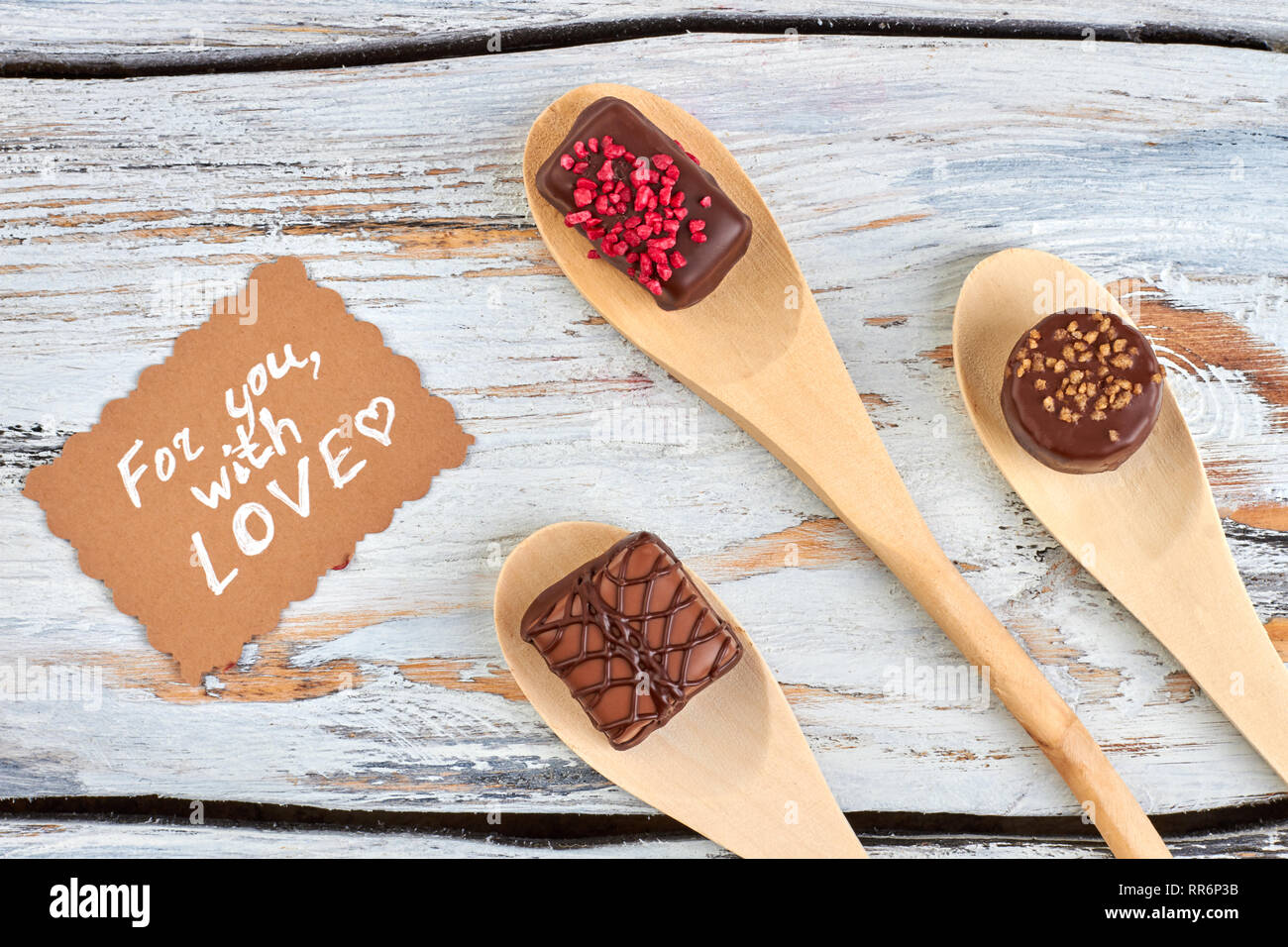 Vintage wooden spoons with chocolate candies Stock Photo - Alamy