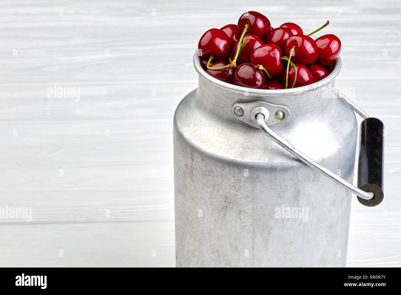 Ripe natural cherries in metal bucket Stock Photo - Alamy