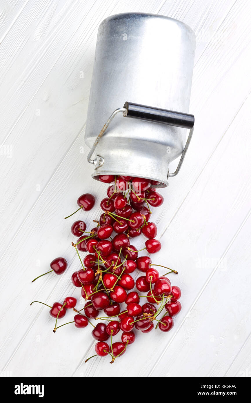 Fresh ripe cherries spilled out from pot Stock Photo - Alamy