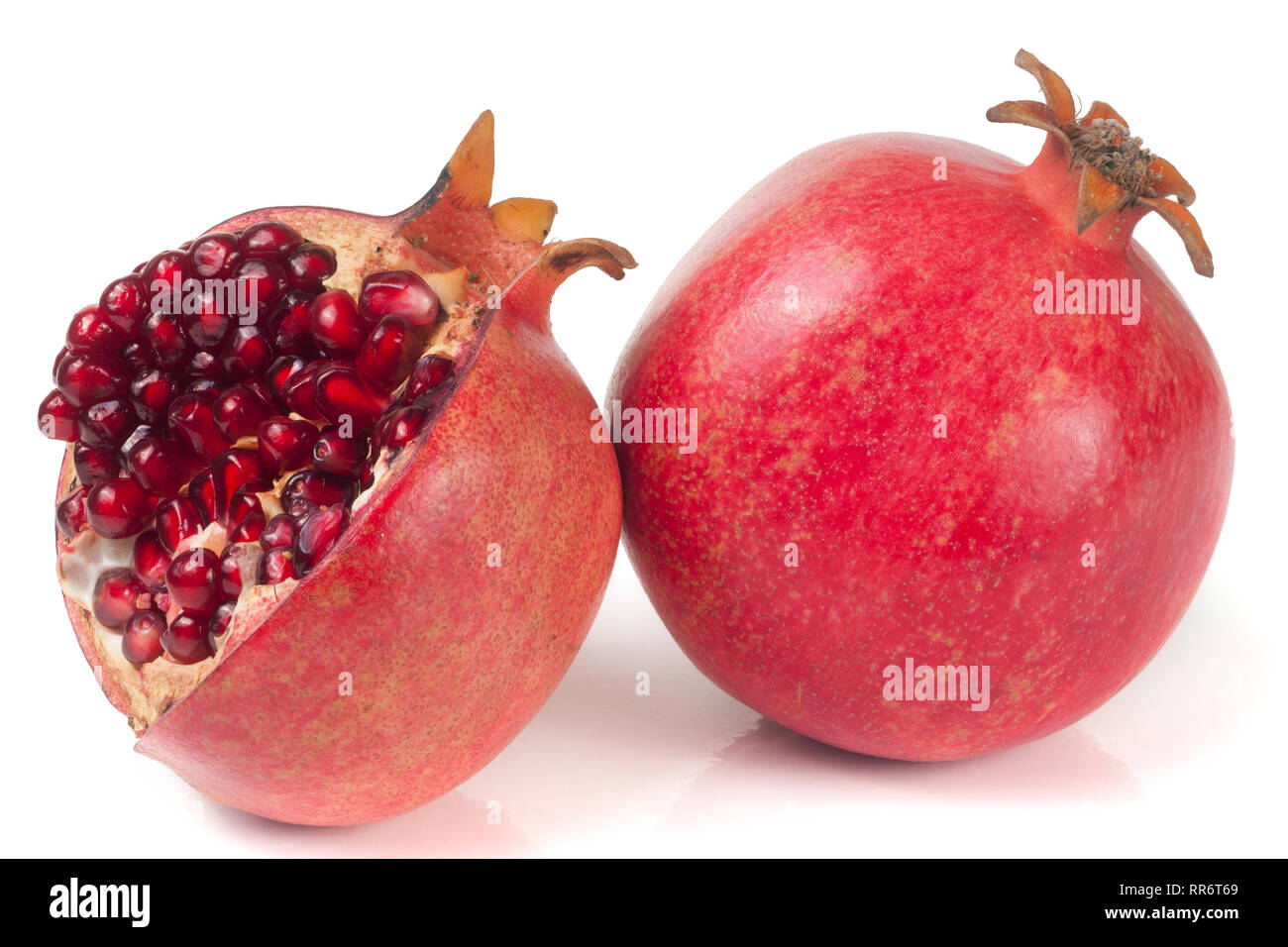 two pomegranate isolated on a white background Stock Photo - Alamy