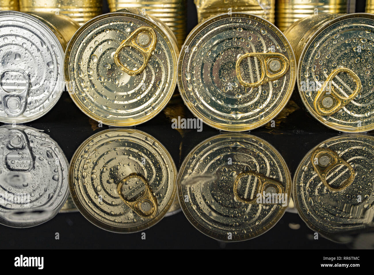 A wet can with vegetables. Drops of water on a metal can lid. Dark ...