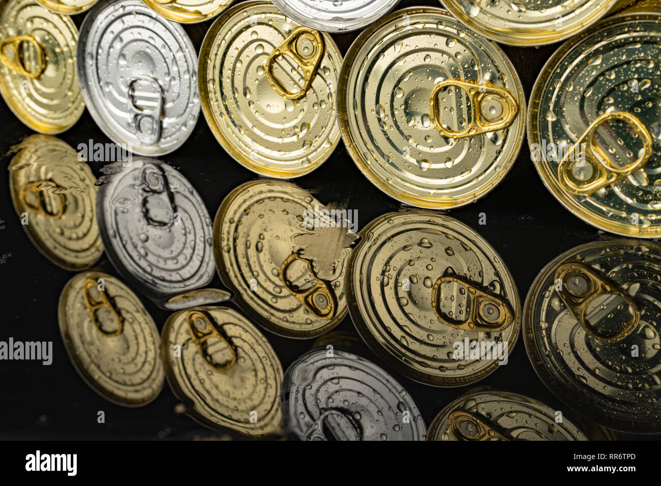 A wet can with vegetables. Drops of water on a metal can lid. Dark ...