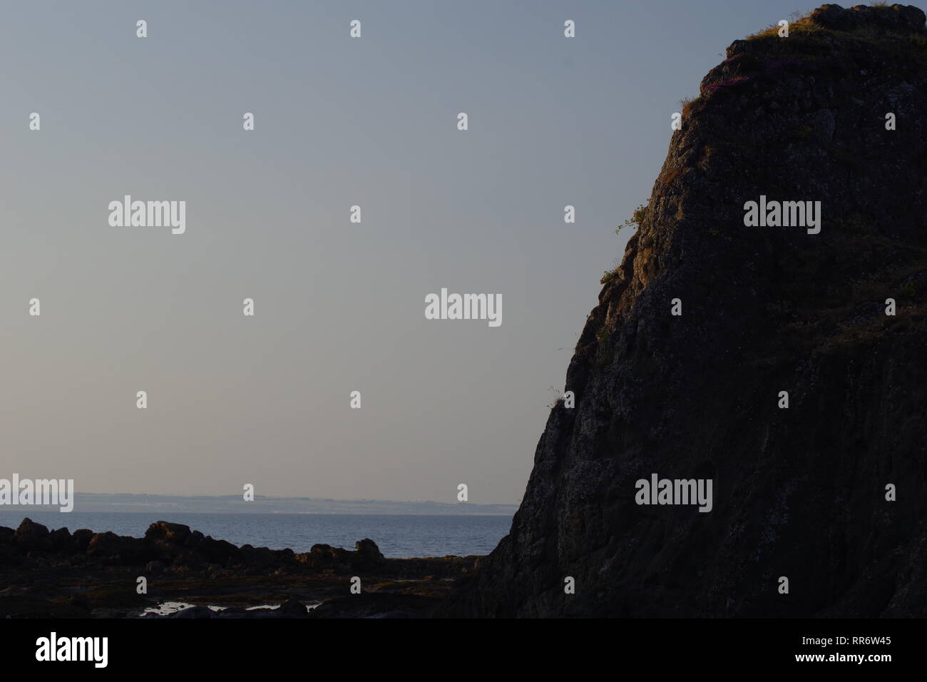 Silhouette of the Rock and Spindle at Sunset. Volcanic Neck of Tuff and ...