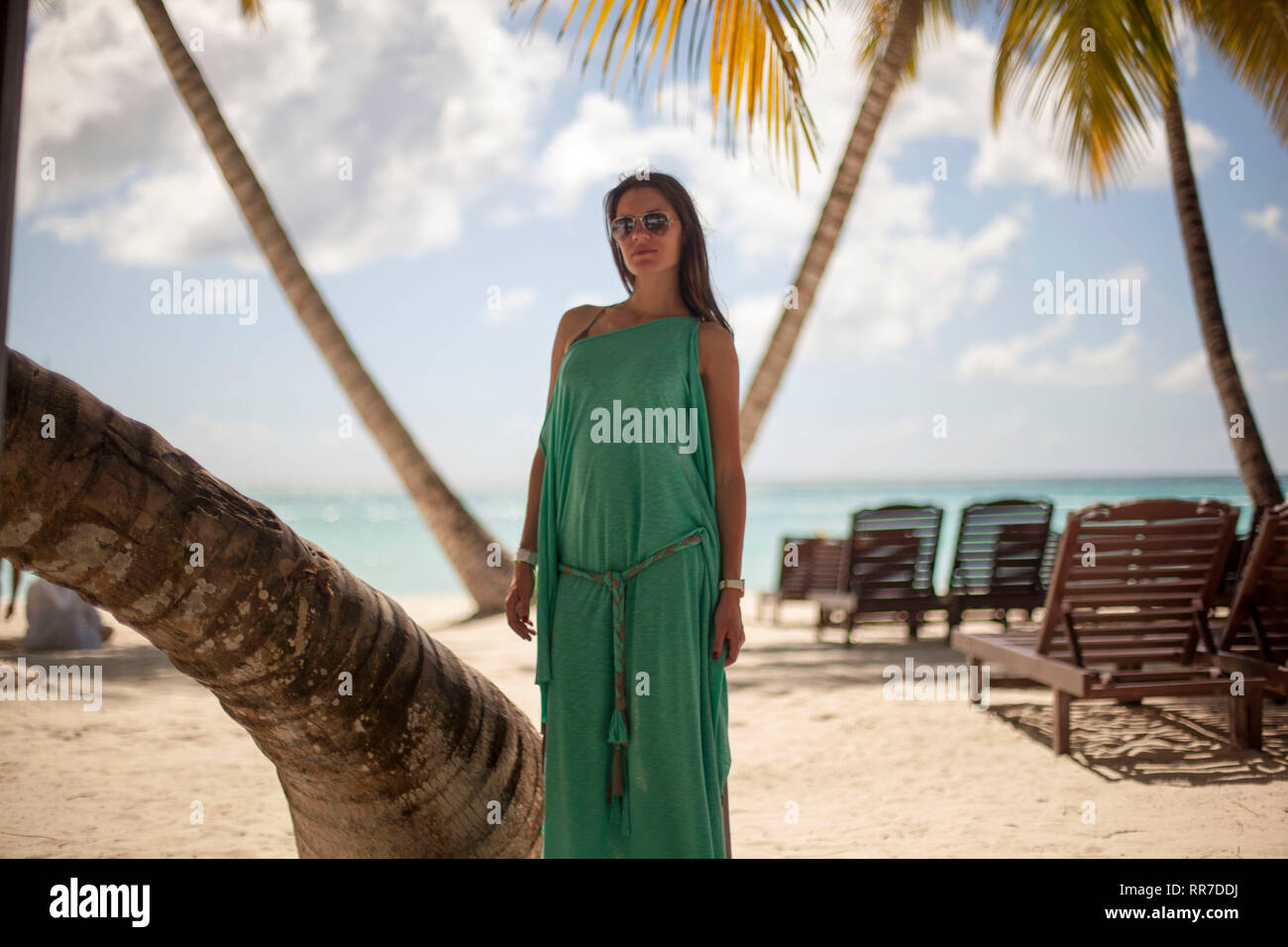 Woman in under a palm tree enjoying the Caribbean beach Stock Photo - Alamy