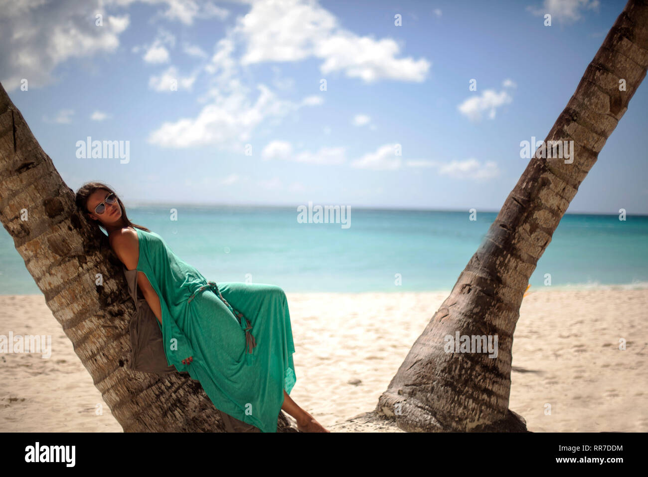 Woman in under a palm tree enjoying the Caribbean beach Stock Photo - Alamy